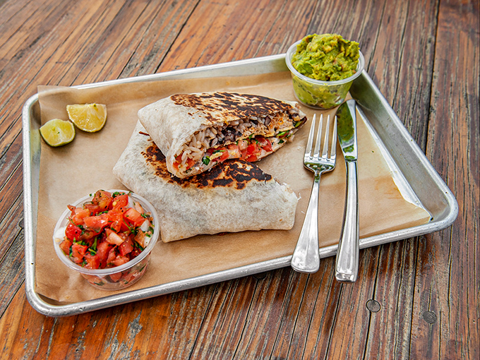 This isn't just breakfast wrapped in a tortilla—it's morning salvation with perfectly charred edges and fresh accompaniments that demand a moment of silent appreciation.