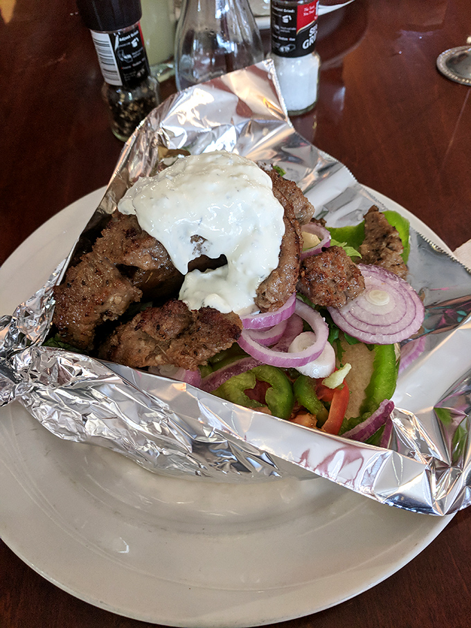 This isn't just a gyro—it's a masterclass in the art of perfect meat-to-sauce ratio. That tzatziki cascade is what dreams are made of.