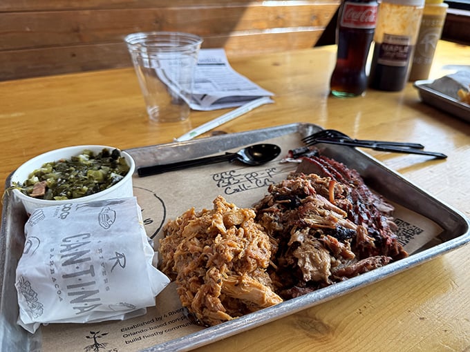 Pulled pork that doesn't just fall apart—it surrenders completely, alongside collard greens that have clearly been simmering since the Carter administration.