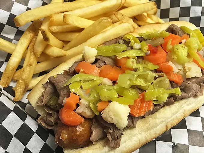 This isn't just a sandwich; it's architecture – layers of tender beef supporting a perfect balance of peppers, with fries standing guard alongside.
