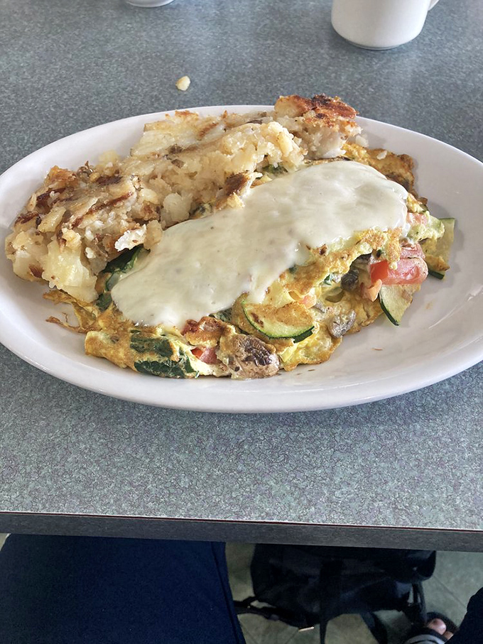 Vegetables finding their higher purpose in life: becoming part of this glorious omelet. That cheese blanket isn't just melted—it's embracing.