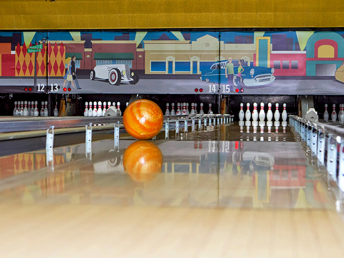 That vintage mural behind the pins takes you back to simpler times when tail fins ruled and bowling was America's favorite pastime.