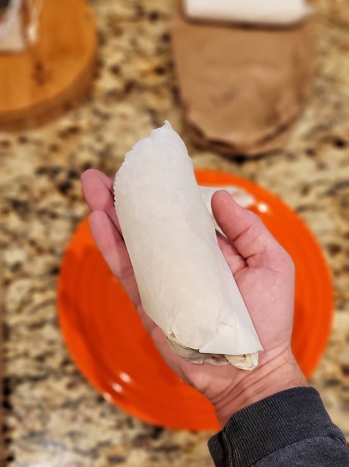 Simplicity wrapped in flour—this white-wrapped wonder holds the key to breakfast bliss, sitting proudly on its bright orange throne.
