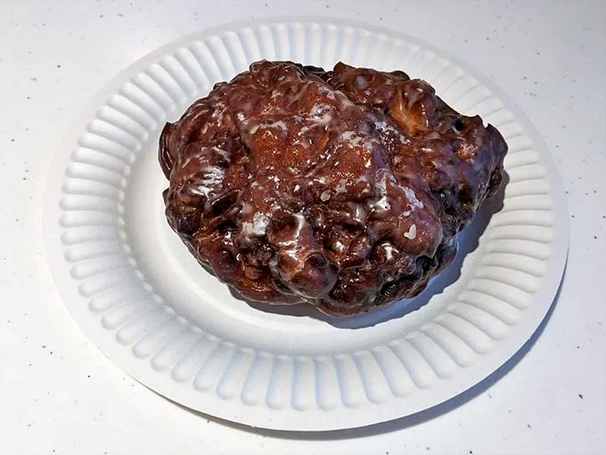 This isn't just an apple fritter; it's edible architecture—a masterpiece of caramelized crust, tender interior, and apple-cinnamon magic.
