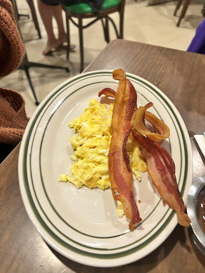 Scrambled eggs so fluffy they could float away if not anchored by that magnificent bacon – thick-cut and perfectly crisped to breakfast perfection.