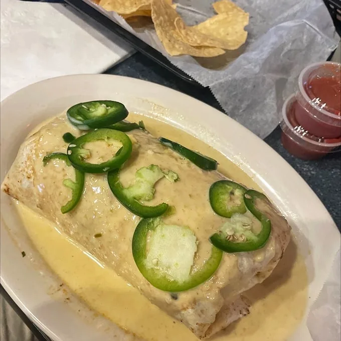 The wet burrito – where cheese and green chilies perform a duet so harmonious it deserves its own jazz quartet. Those jalapeños aren't just garnish; they're exclamation points.