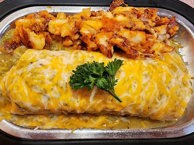 This breakfast burrito isn't just food; it's a golden-topped miracle wrapped in a tortilla with home fries that deserve their own fan club.