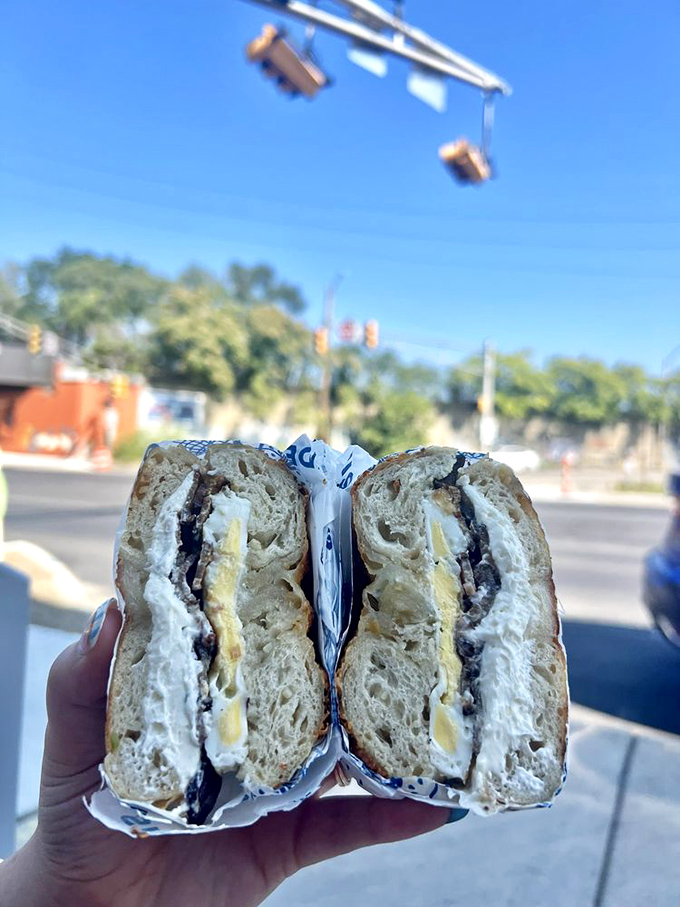 This isn't just a breakfast sandwich—it's morning architecture. The cross-section reveals layers of flavor that would make a geologist weep.