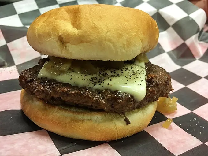 Behold the star of the show: a perfectly charred burger with melty cheese and caramelized onions. This isn't fast food; it's good food, fast. 