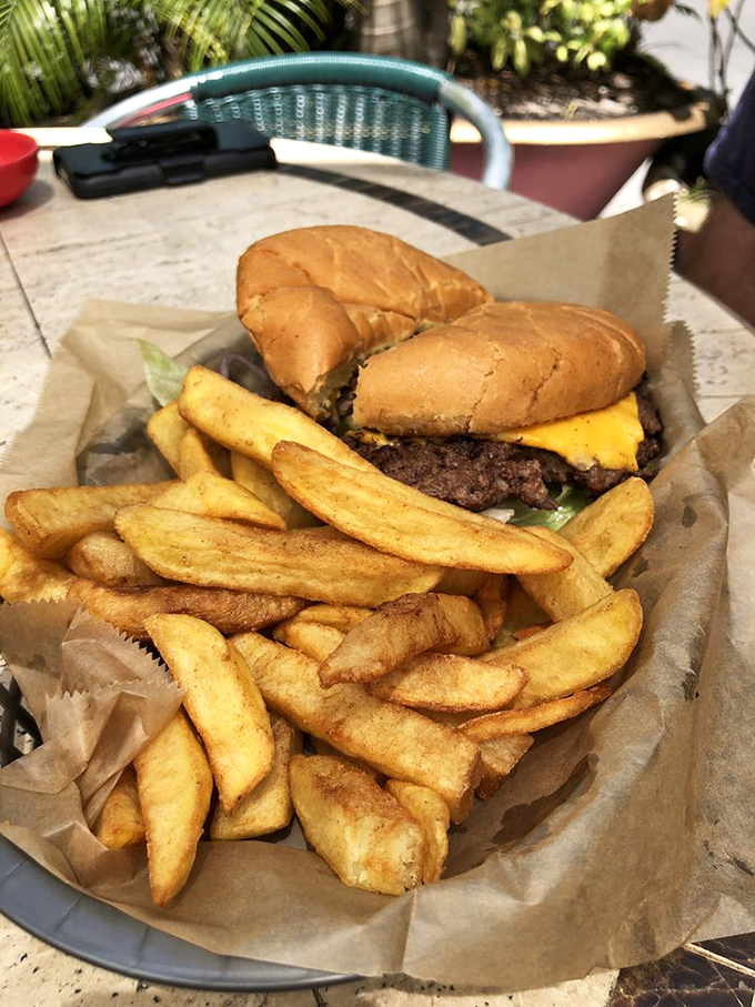 This isn't just a burger – it's edible nostalgia, served with golden fries that achieve that perfect crisp-outside, fluffy-inside harmony that haunts your dreams.