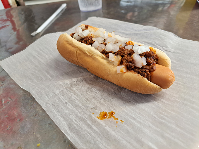 This isn't just a chili dog; it's a Roanoke handshake—meat, bun, and that signature chili topped with diced onions that crunch with each bite.