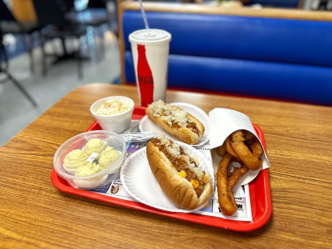 The star of the show: a perfectly split dog nestled in a steamed bun, smothered with that legendary chili sauce and crowned with diced onions.