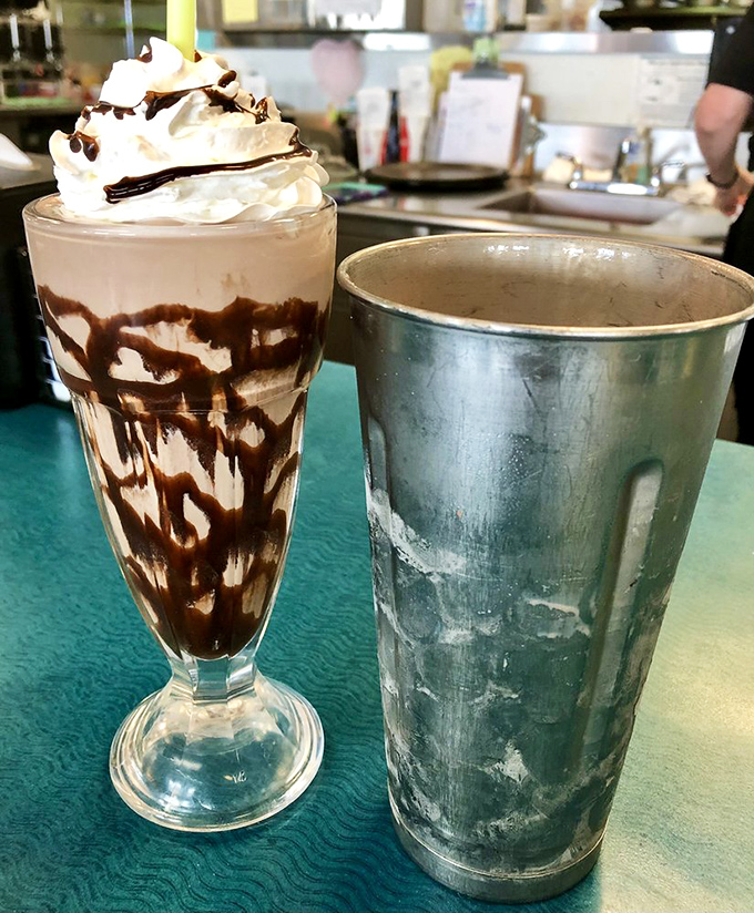 The strawberry milkshake wears its sprinkles like confetti, while its chocolate companion stands by in creamy solidarity. Together, they're worth every brain freeze.