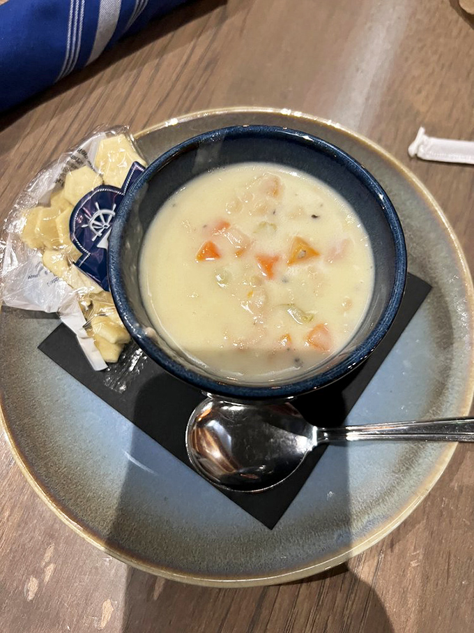Creamy comfort in a blue ceramic bowl. This isn't just clam chowder—it's a warm hug from the Atlantic Ocean that somehow found its way to Indiana.