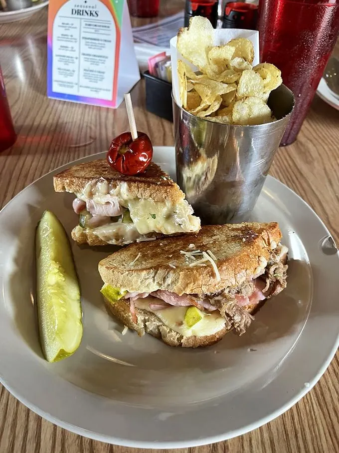 Layers of melted cheese embrace savory meats between perfectly toasted bread—this isn't your childhood sandwich, it's your childhood sandwich's glow-up.