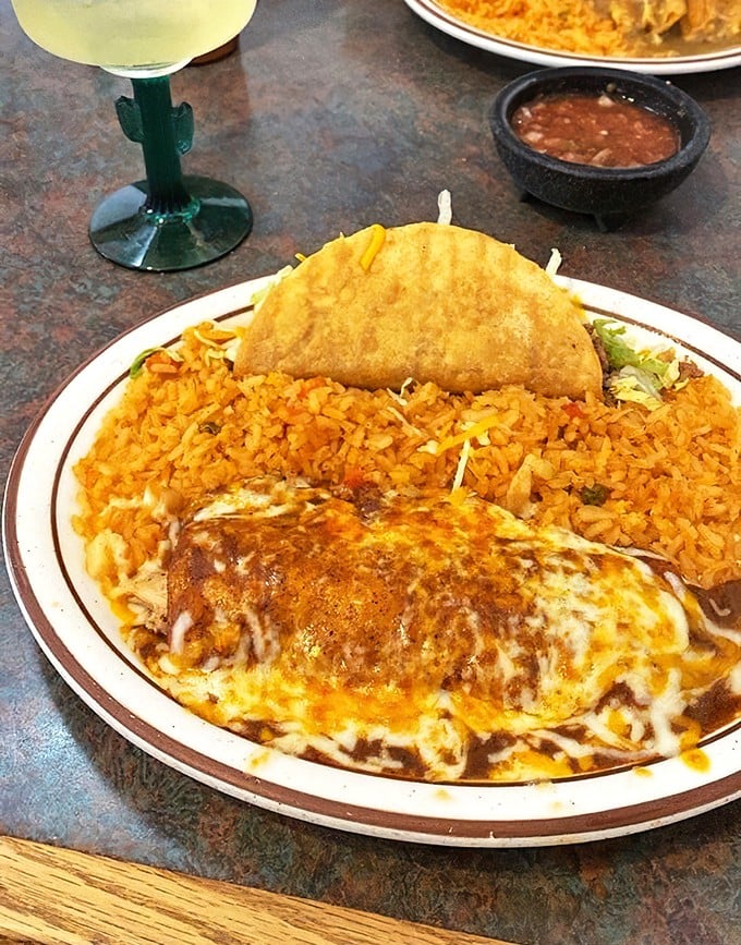 This isn't just dinner; it's edible geography. The enchilada's rich sauce, golden rice, and crispy taco create a landscape of flavors worth exploring.