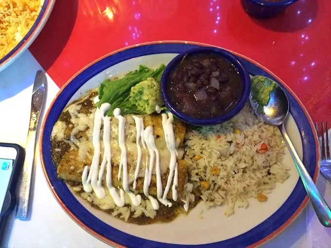 These enchiladas aren't just covered in sauce, they're swimming in it—the way all proper enchiladas should be, like Olympic athletes in a pool of flavor.