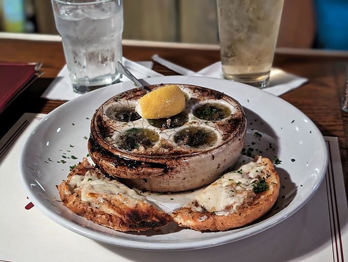 Escargot swimming in garlic butter—proof that sometimes the best seafood isn't seafood at all. Your bread basket will thank you for the dipping opportunity.
