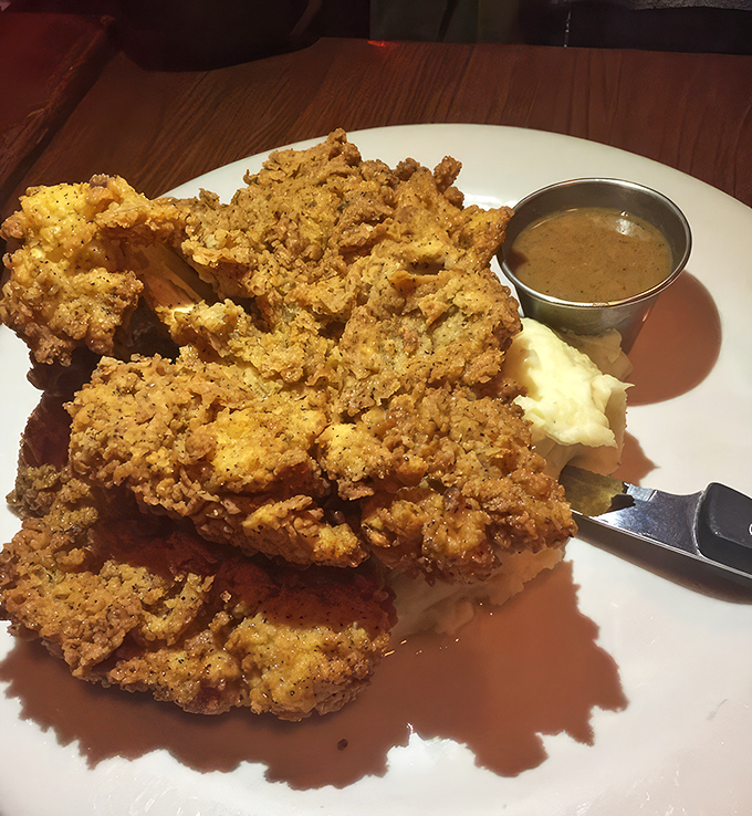 Golden armor shattering to reveal juicy meat beneath—this fried chicken isn't just a meal, it's an event worth planning your day around.