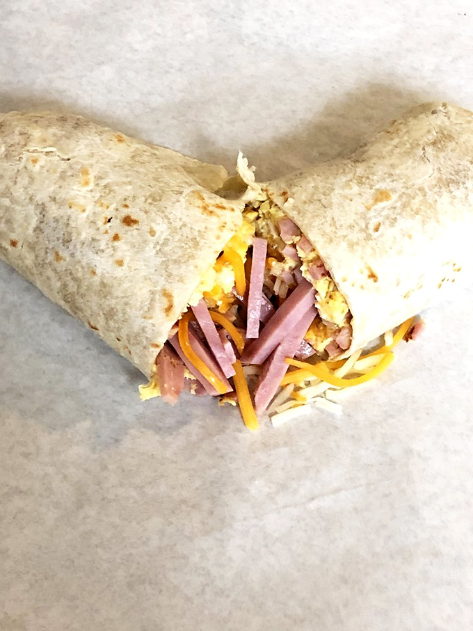 This loaded breakfast burrito doesn't care what time your watch says—it's always the right moment for eggs, ham, and cheese wrapped in tortilla bliss.