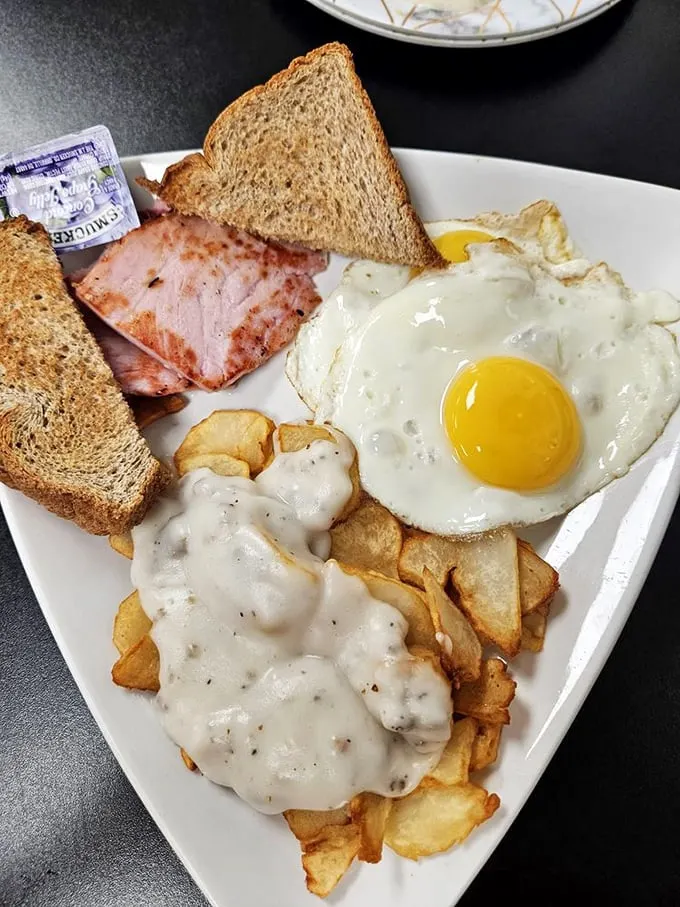This ham breakfast plate doesn't need Instagram filters—just your undivided attention. That sunny-side-up egg is practically winking at you.