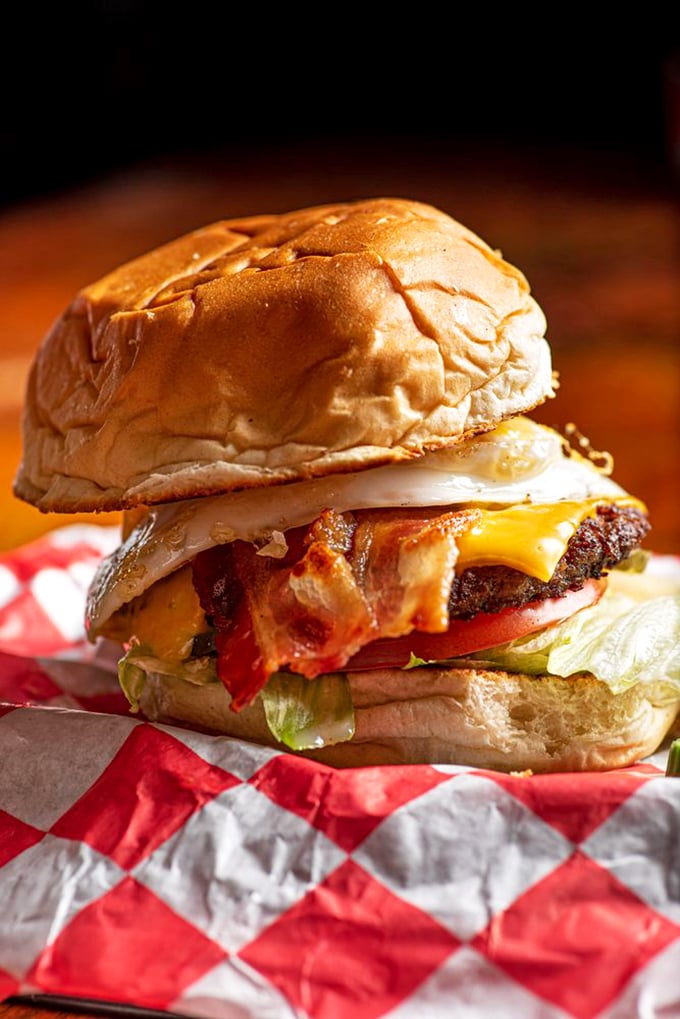 Meet the Hangover Burger—where bacon, egg, and cheese join forces atop a perfectly seared patty. Breakfast and lunch having a delicious affair.