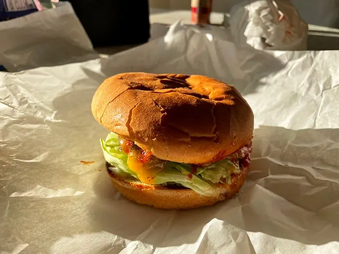 The Hickory Burger arrives like a humble masterpiece—melted cheese cascading over the patty, crisp lettuce peeking out, all nestled in a perfectly toasted bun.