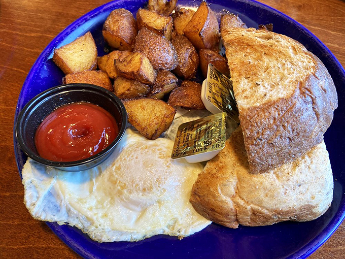 Breakfast simplicity at its finest: golden home fries, perfectly cooked eggs, and toast that makes you question why anyone would skip the most important meal.