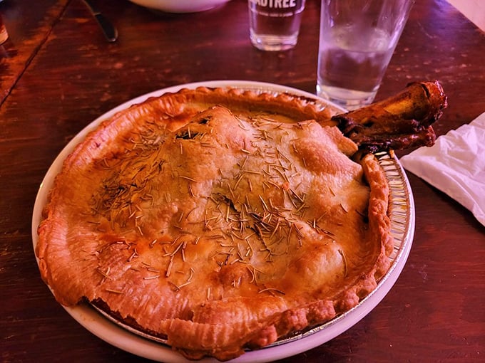 That's not just a pot pie—it's edible architecture with a bone handle poking through like nature's own "dig here" sign.