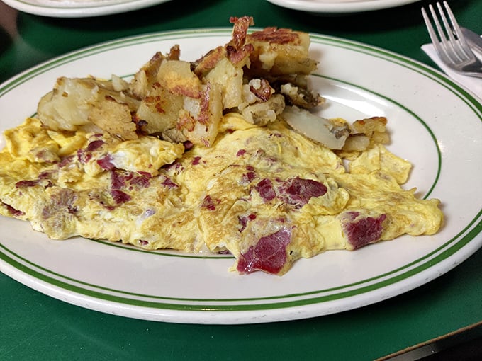 Behold the ham and cheese omelet with home fries—a masterclass in breakfast engineering where every bite delivers that perfect egg-to-filling ratio.