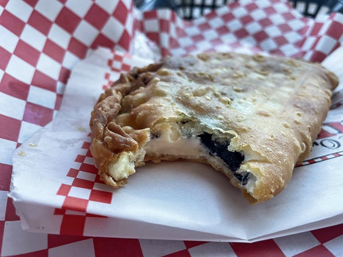 Behold the Oreo cheesecake fried pie in its natural habitat—half-eaten because nobody has the willpower to pause for photos before diving in.