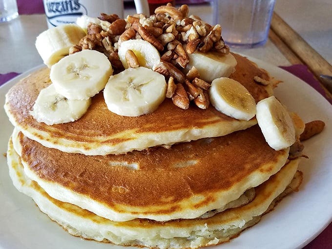 Pancake perfection doesn't need to be complicated. Golden discs topped with fresh bananas and pecans—simple pleasures that make mornings worth facing.
