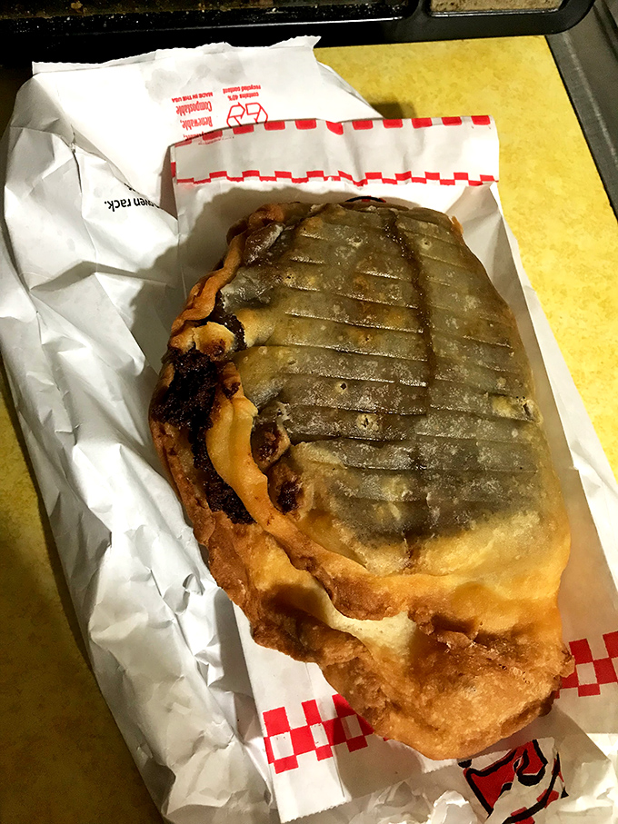 This isn't just a fried pie—it's edible architecture with crisp, ridged edges giving way to a dark, mysterious filling that promises satisfaction.