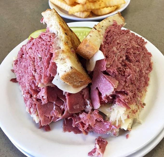 Not so much a sandwich as a skyscraper of pink perfection – this Reuben requires both hands, several napkins, and zero shame.