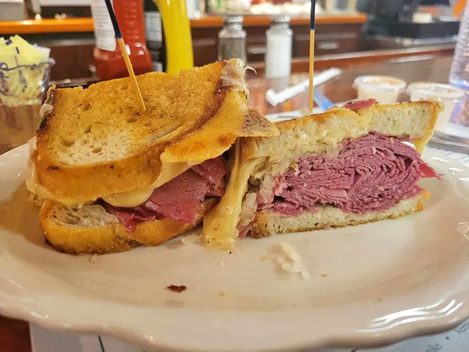 Architecture students should study the Reuben sandwich—a perfectly engineered tower of pastrami, Swiss, and sauerkraut held together by nothing but hope and toothpicks.