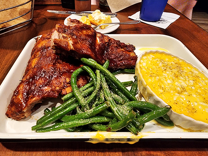 Ribs that don't just fall off the bone—they practically leap into your mouth, accompanied by vibrant green beans and corn pudding that deserves its own fan club.