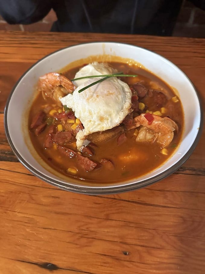 Shrimp swimming in a savory broth topped with a perfectly poached egg—proof that breakfast can be both sophisticated and soul-satisfying.