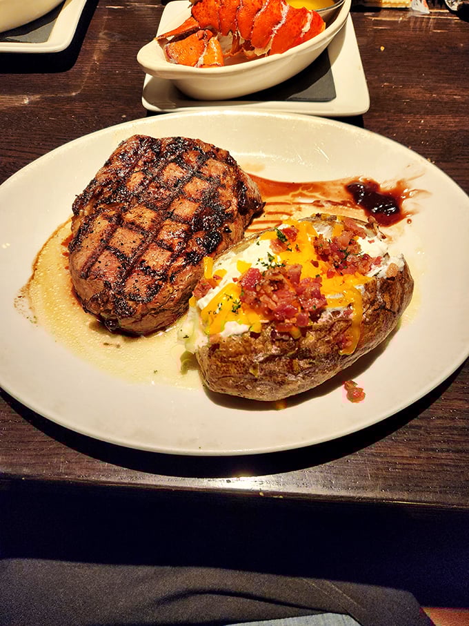 Behold the perfect marriage: A steak with grill marks that could make a geometry teacher weep, alongside a loaded potato that's dressed better than I am.