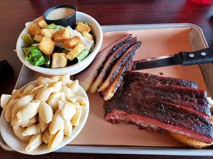 Behold the perfect marriage of protein and sides—brisket with that coveted smoke ring alongside creamy mac and cheese.