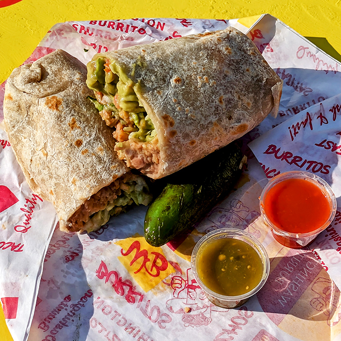 Behold the star of our show – wrapped in foil like a present, this burrito delivers more joy than most birthday gifts.