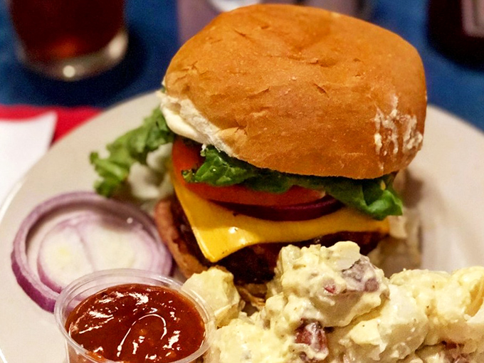 This isn't just a burger—it's architecture. The melted cheese cascades down the patty like a yellow waterfall of joy.