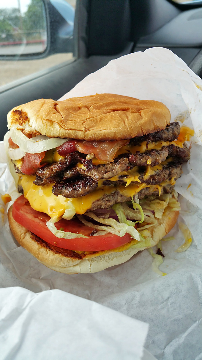 Behold the architectural marvel that is Hometown's triple cheeseburger—where beef, cheese, and fresh veggies create the Taj Mahal of handheld meals.