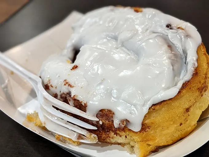 This cinnamon roll isn't just breakfast; it's an event. That glorious icing doesn't drip—it cascades with the confidence of a waterfall in a shampoo commercial.