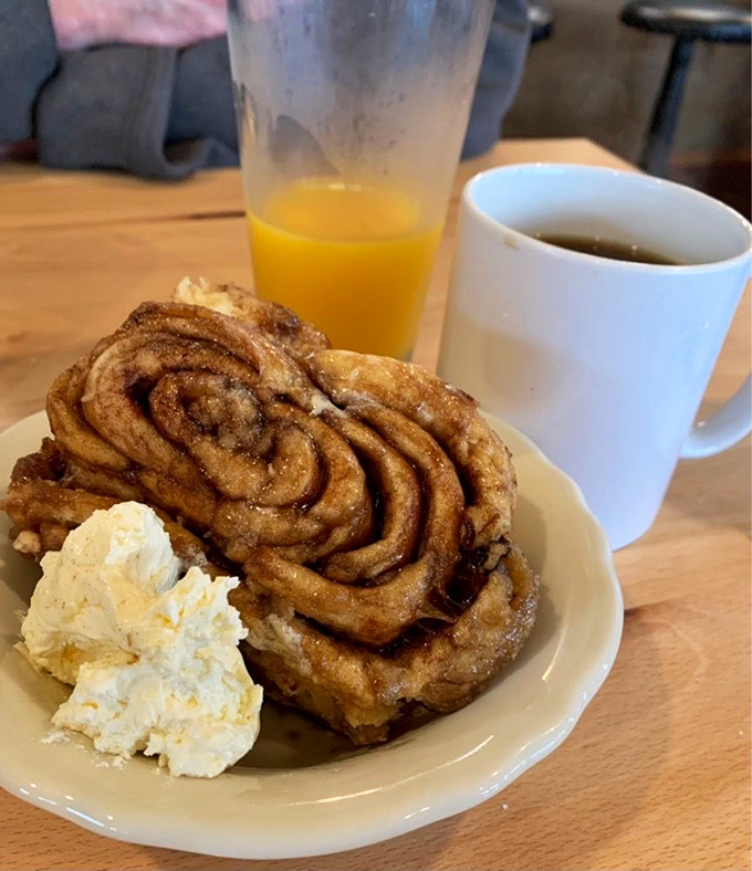 This cinnamon roll isn't just breakfast – it's an event. With a dollop of butter melting into those warm, spiced swirls, it's what breakfast dreams are made of.