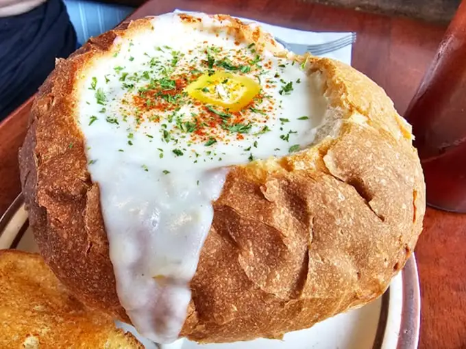 A bowl of creamy chowder with buttery toast—the kind of simple perfection that makes you wonder why you'd ever eat anything else.