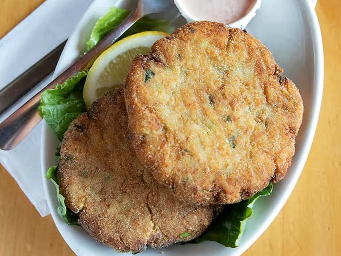 Golden-brown perfection that makes you forget your table manners. These crab cakes deliver that magical ratio of crab meat to just enough binding to hold memories together.