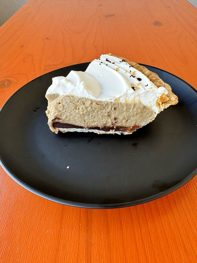This chocolate cream pie topped with billowy whipped cream isn't just dessert; it's what clouds would taste like if they were made by someone who really, really loves you.