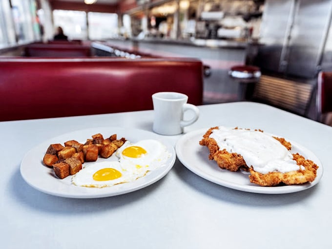 Sunny-side up eggs and golden hash browns share the plate with country-fried steak smothered in creamy gravy—breakfast of champions, Midwest edition.