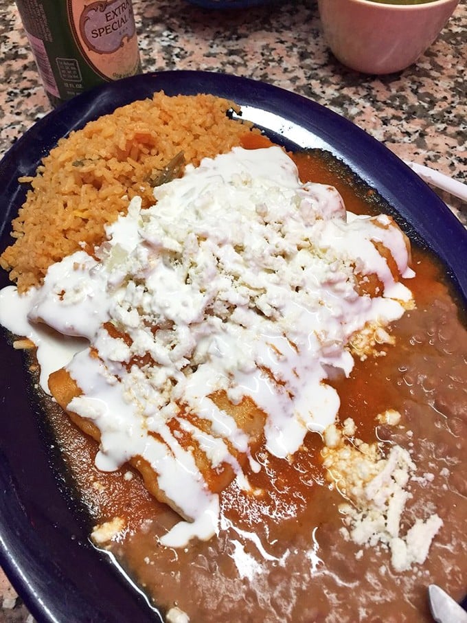 This isn't just an enchilada—it's edible architecture. The perfect ratio of sauce to cheese to filling, with rice playing a supporting role.