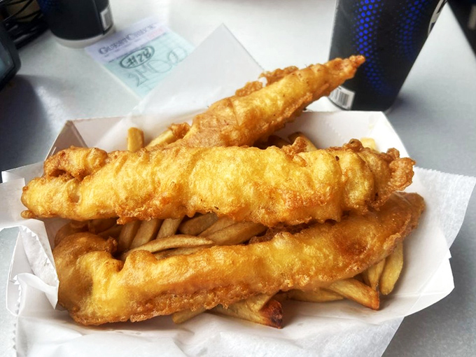 Golden-battered fish fillets lounging atop a bed of crispy fries—the culinary equivalent of a perfect day at the beach.